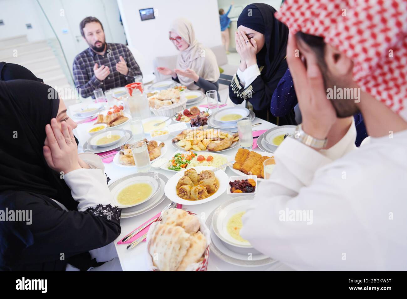Eid Mubarak Muslim people praying before iftar dinner. Eating ...