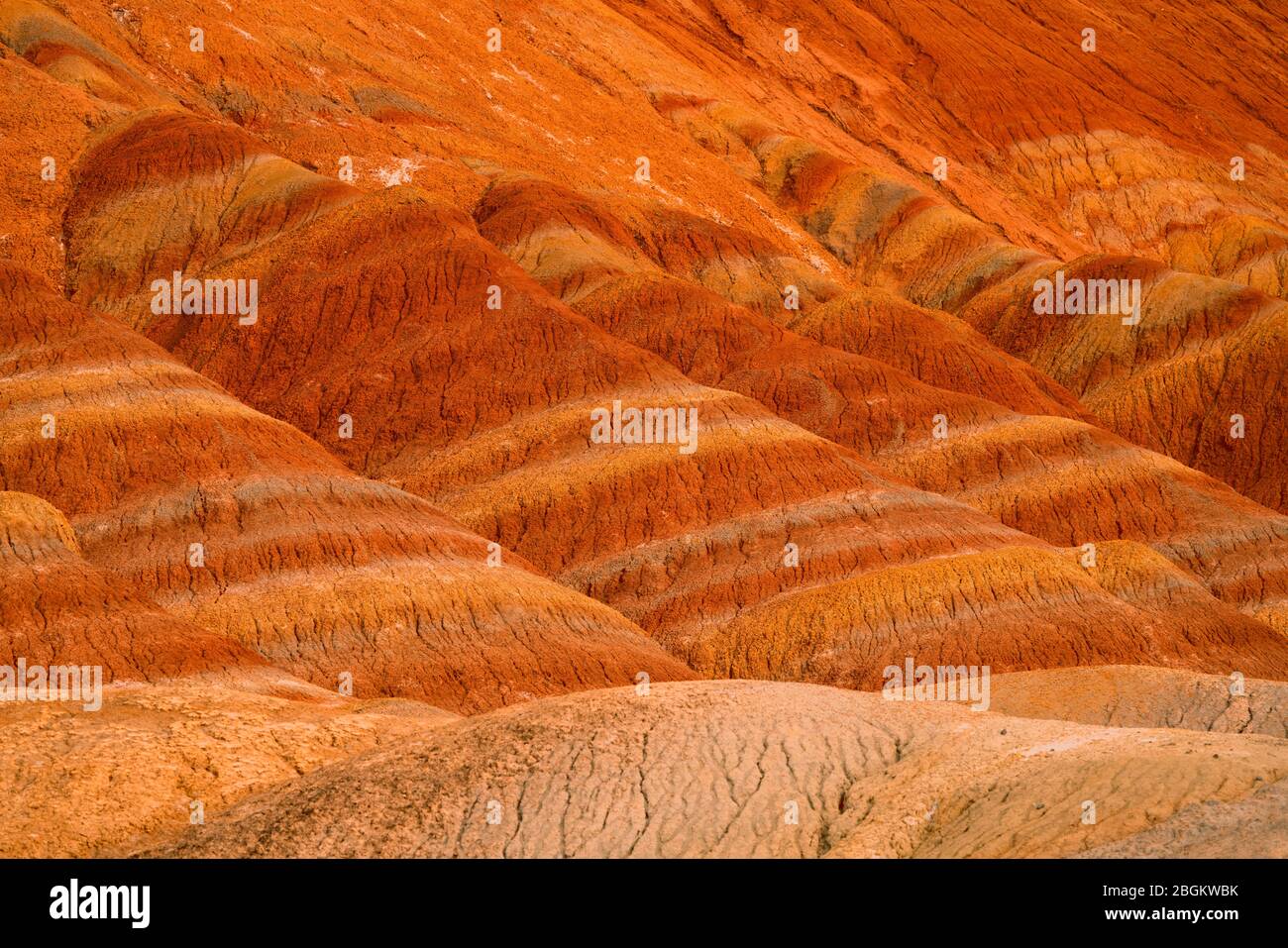 An aerial of mountains of Danxia Landform with colorful strips at Qicai ...
