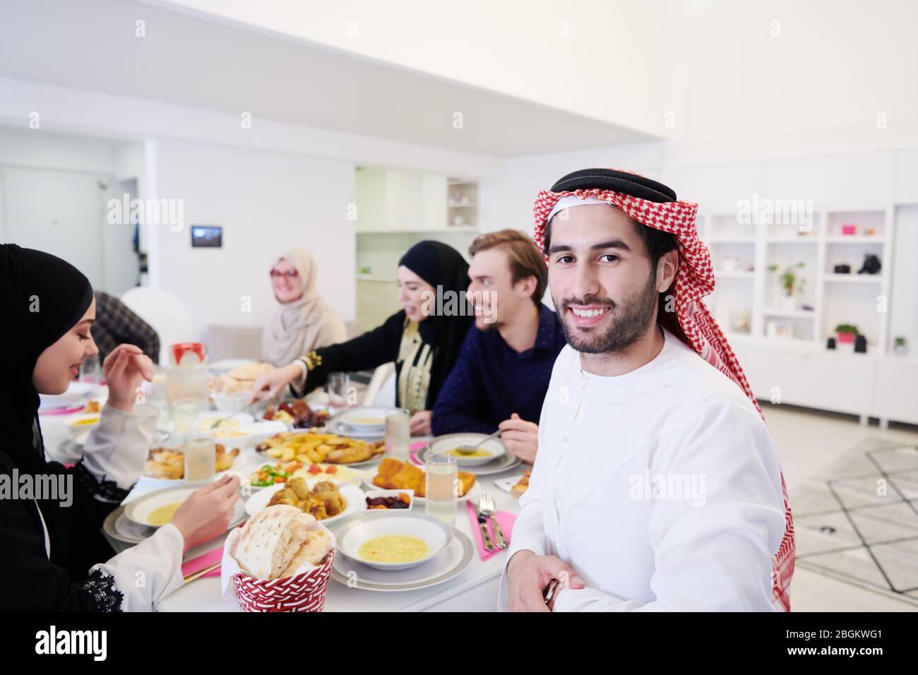 young arabian man having Iftar dinner with muslim family Eating ...
