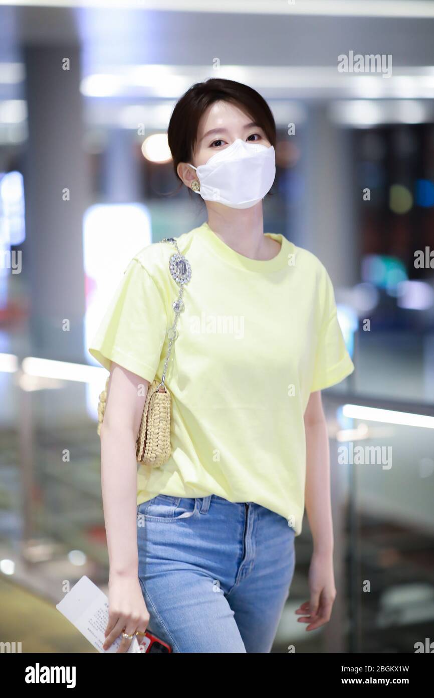Chinese actress Qiao Xin arrives at a Shanghai airport before departure ...