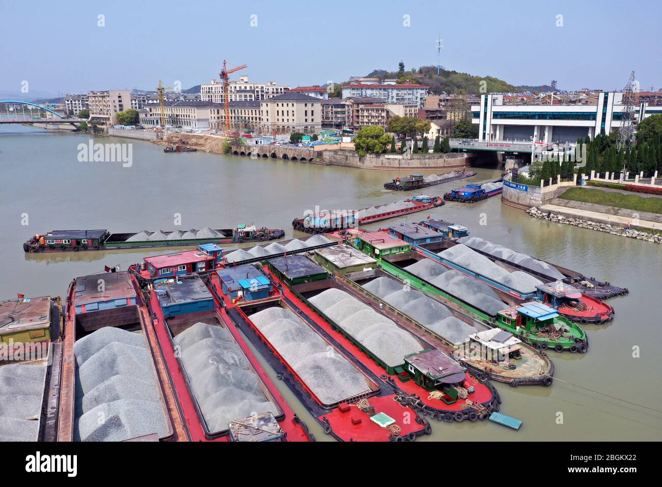 Cargo ships dock by a river bank in Huzhou city, east China's Zhejiang ...