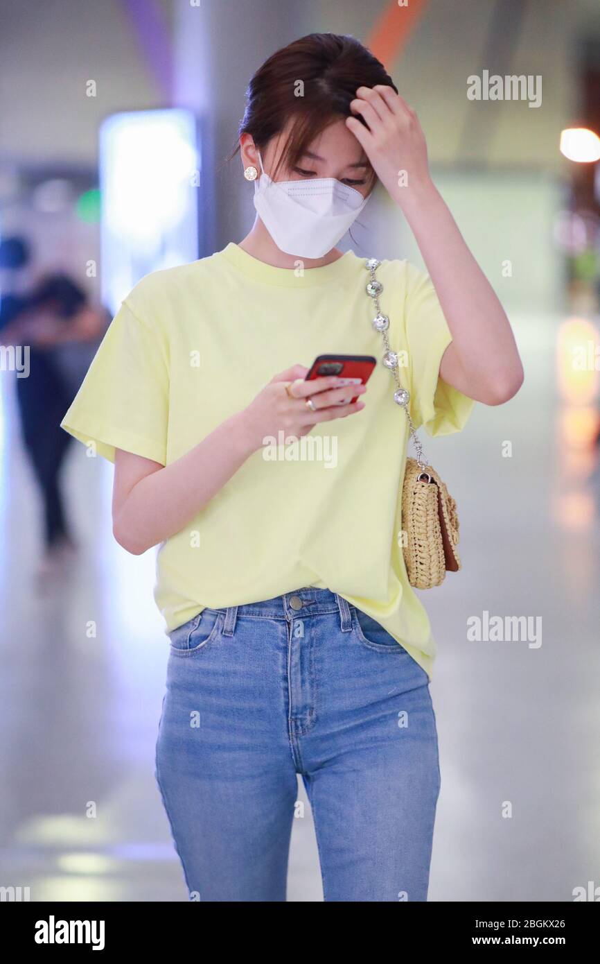 Chinese actress Qiao Xin arrives at a Shanghai airport before departure ...