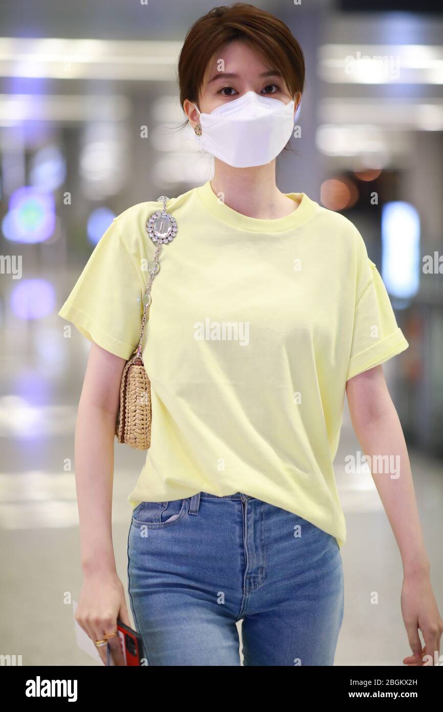 Chinese actress Qiao Xin arrives at a Shanghai airport before departure ...
