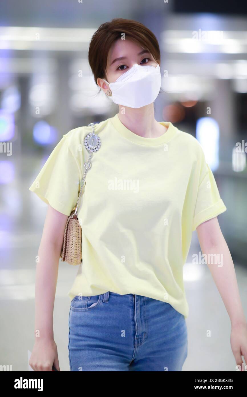 Chinese actress Qiao Xin arrives at a Shanghai airport before departure ...