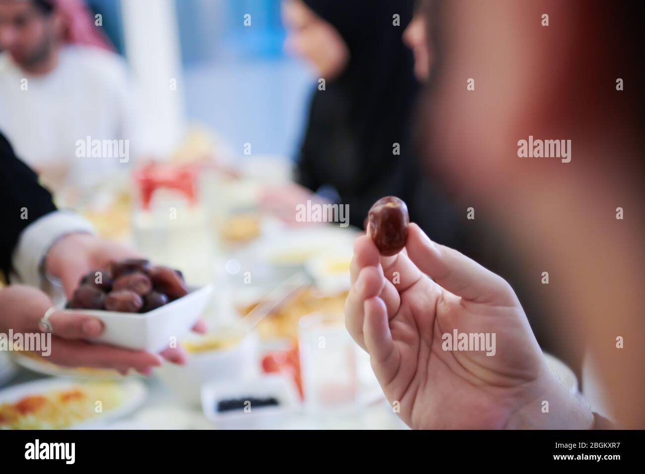 Eid Mubarak Muslim family having Iftar dinner eating dates to break ...