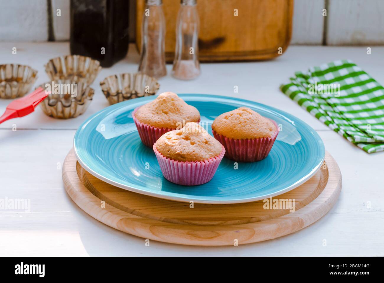Decorated homemade muffins on a blue plate Stock Photo - Alamy