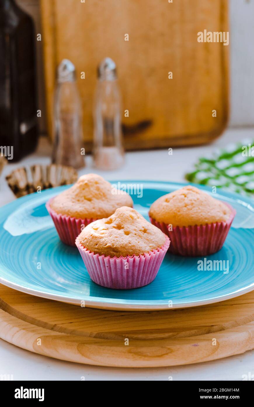 Decorated homemade muffins on a blue plate Stock Photo - Alamy