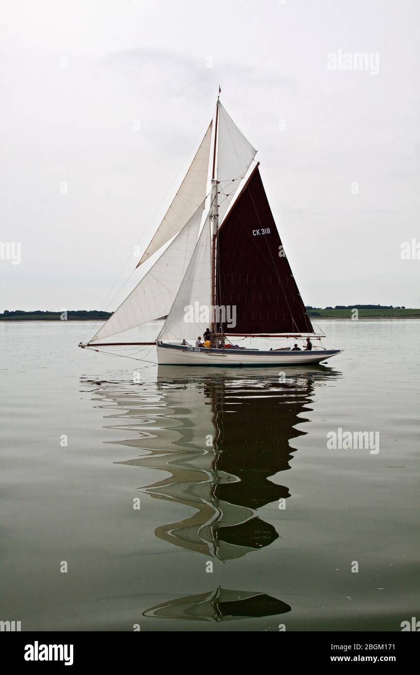 Esseex oyster smack, CK318, Alberta, in full sail with reflections on ...