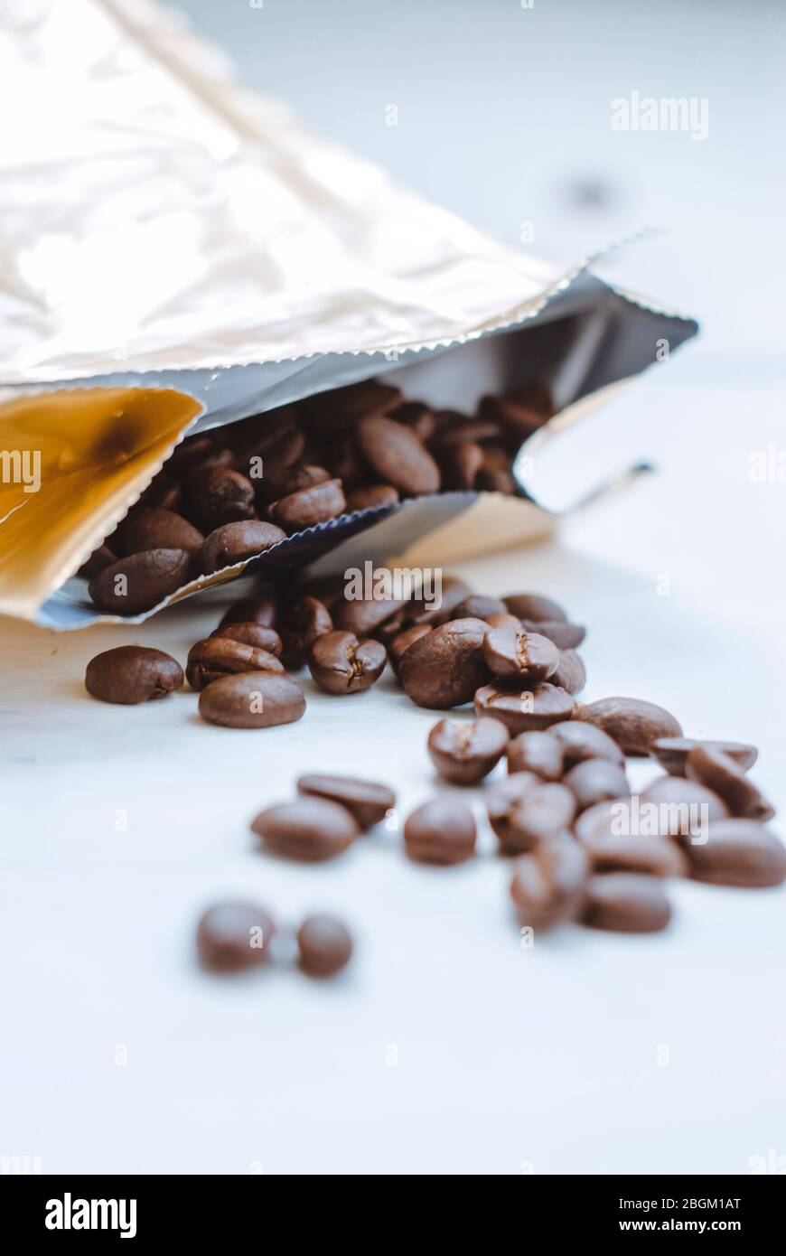 Coffee beans on a light background, close-up Stock Photo - Alamy