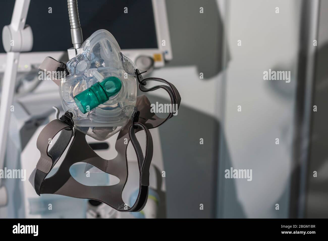 Non-invasive ventlation face mask, on background medical ventilator in ...