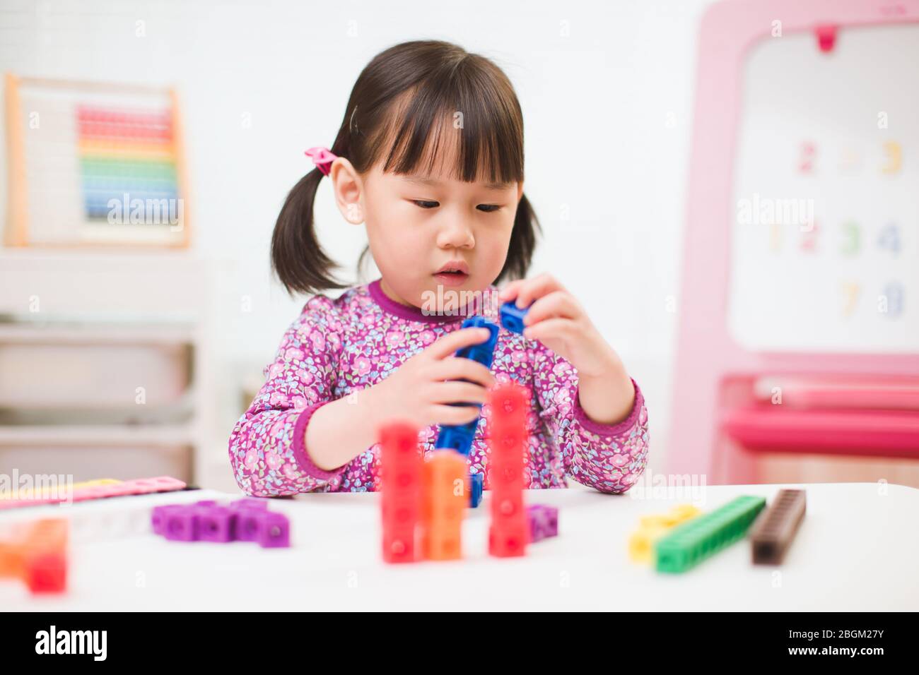 toddler girl play number blocks for homeschooling Stock Photo - Alamy