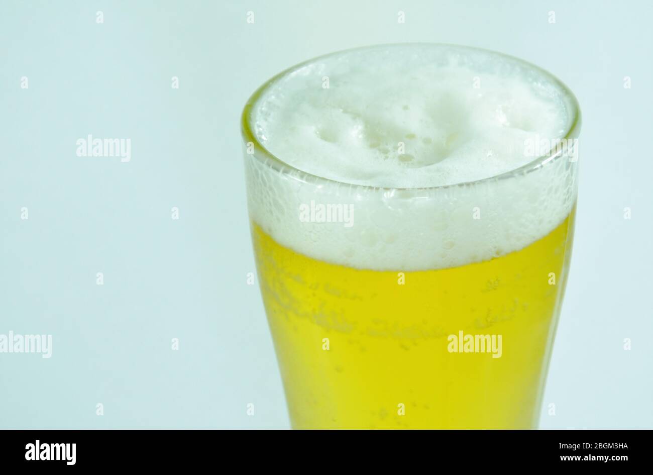 cold beer with frothy in glass on white background Stock Photo - Alamy
