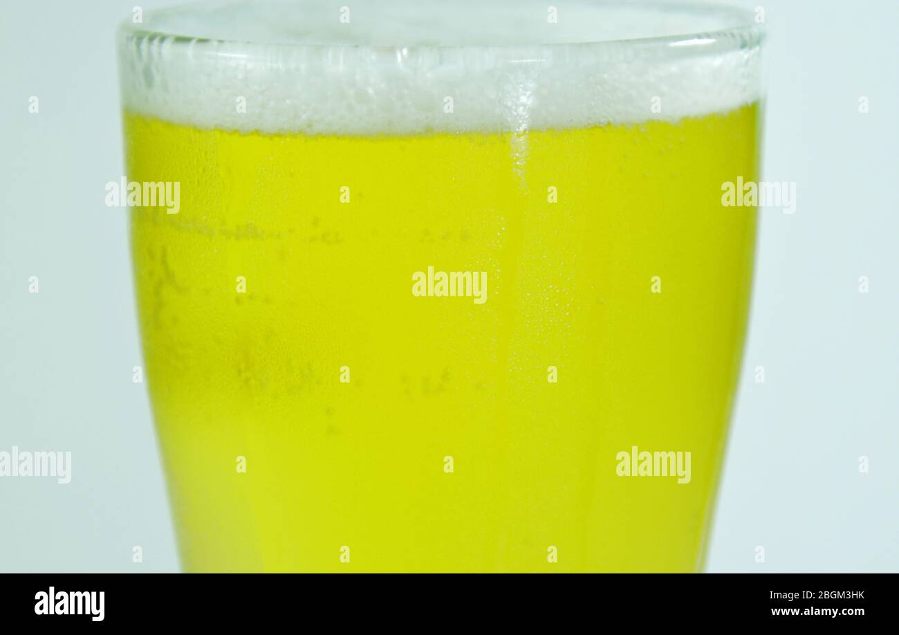 cold beer with frothy in glass on white background Stock Photo - Alamy