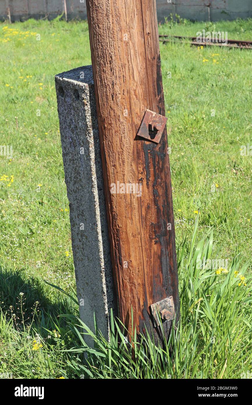 Bottom part of an old wooden electricity pylon Stock Photo - Alamy