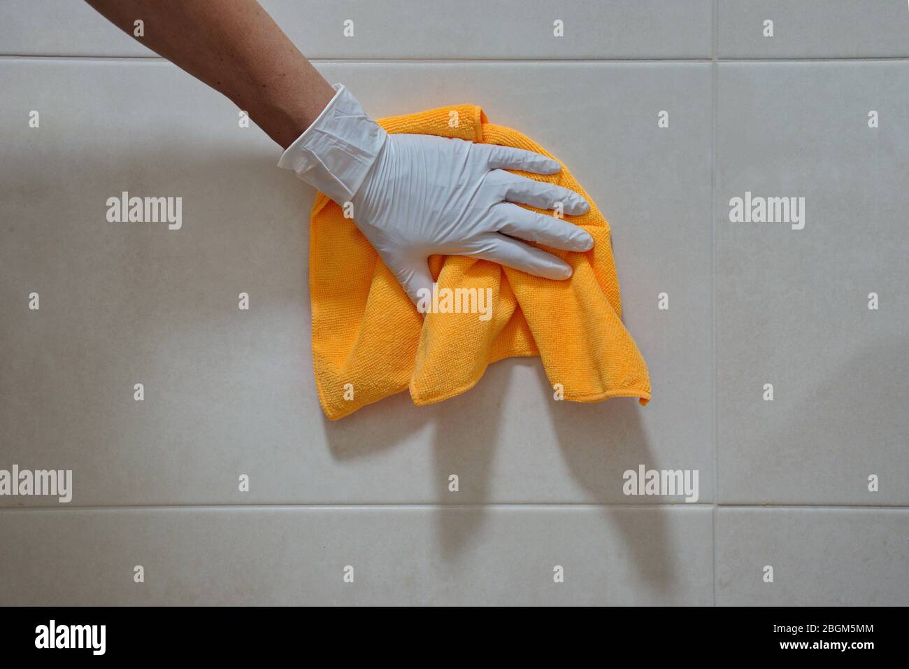 The hand in a white glove with wipe cloth washes a tiles Stock Photo ...