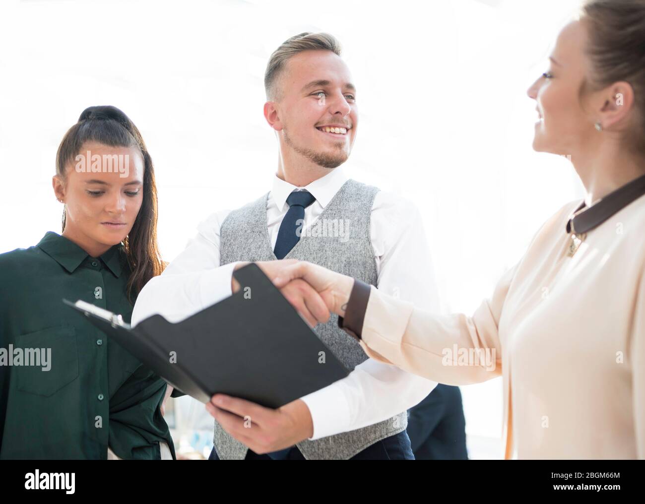 through the glass. business partners shaking hands Stock Photo - Alamy