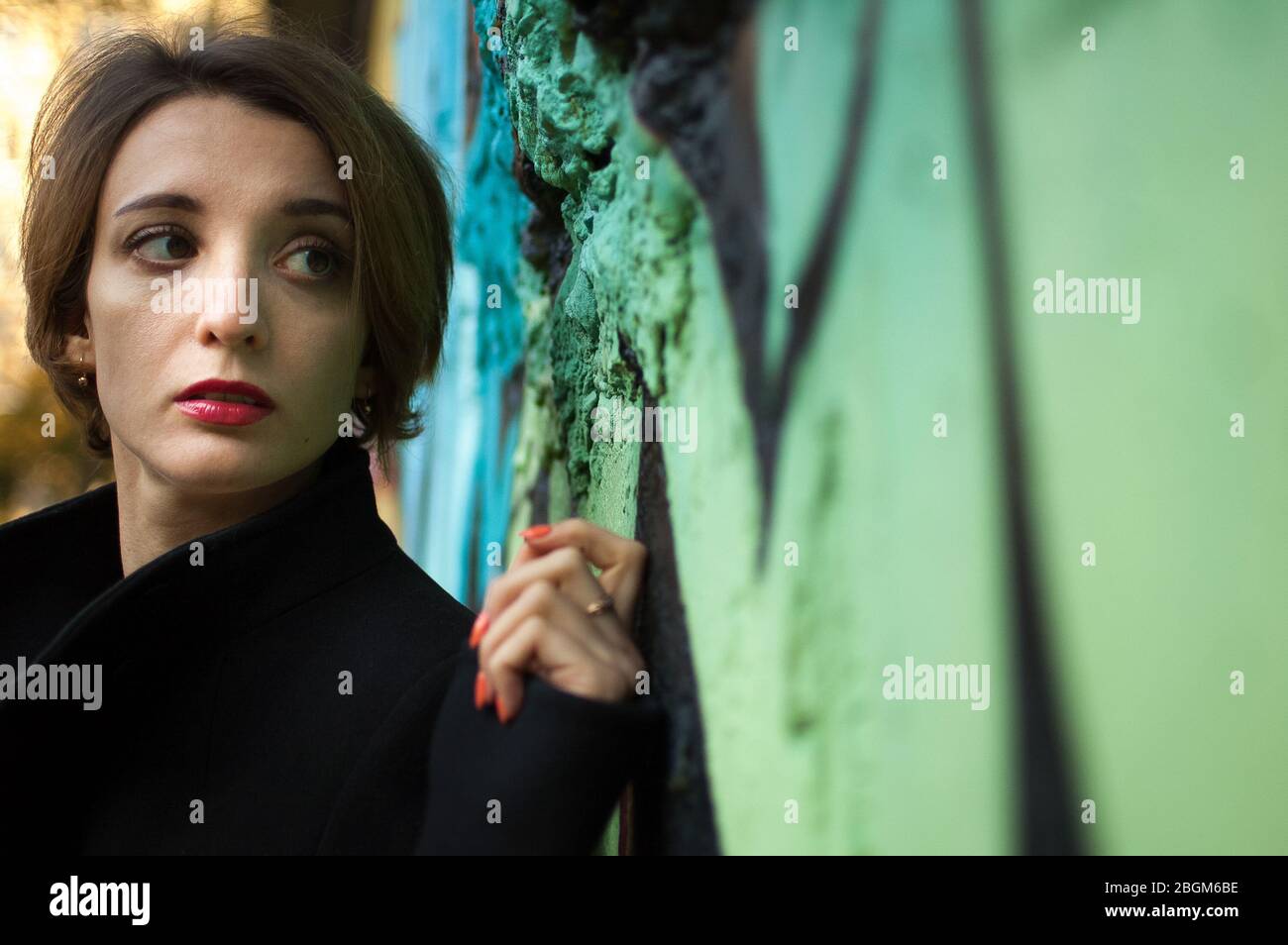 Close-up female portrait of young sad girl with short blonde hair in ...
