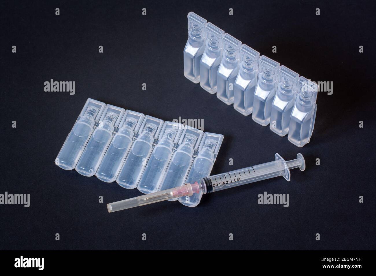 A disposable syringe for personal use and two packs of plastic ampoules ...