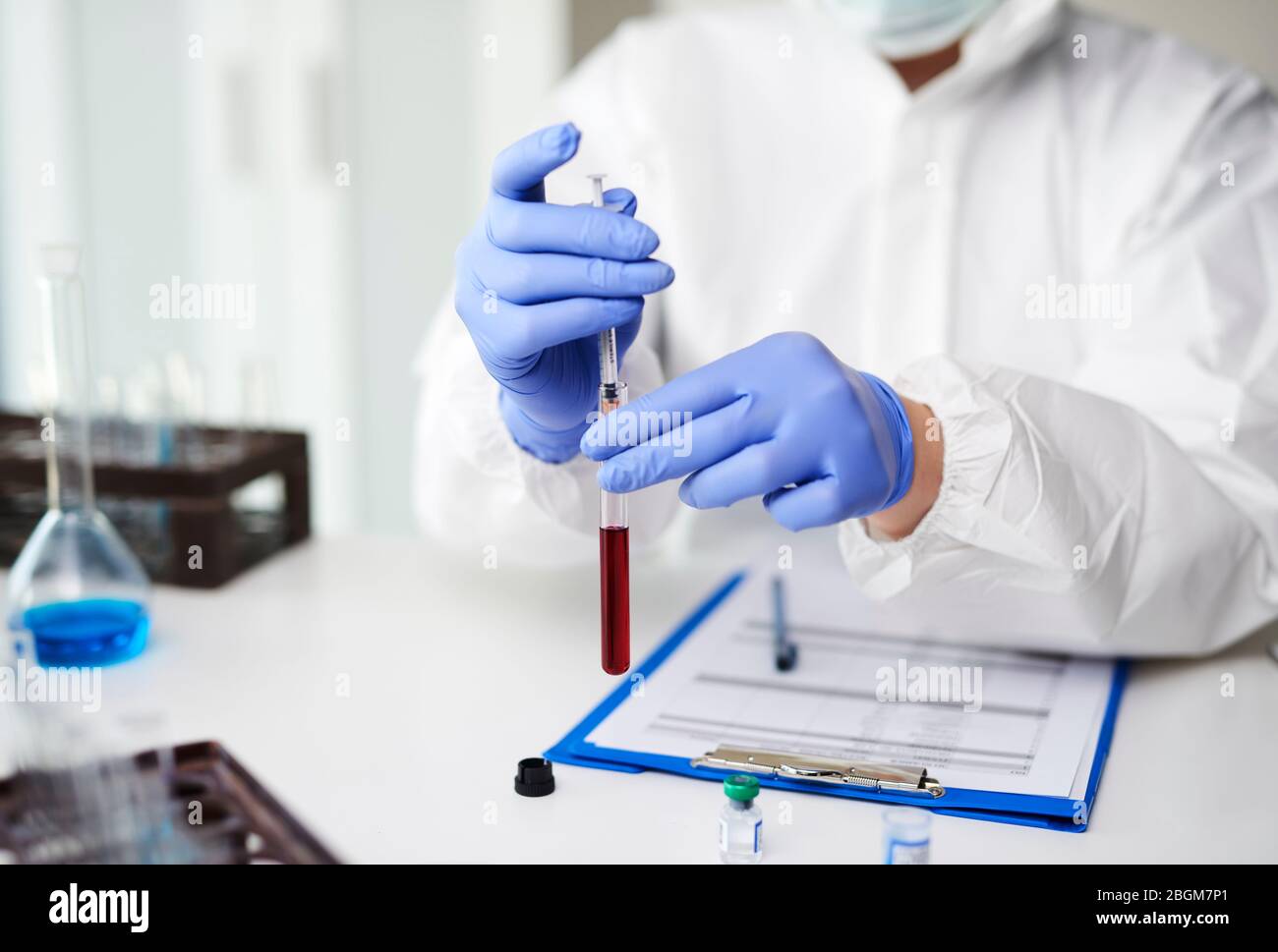 Test tube full of blood and a syringe Stock Photo - Alamy