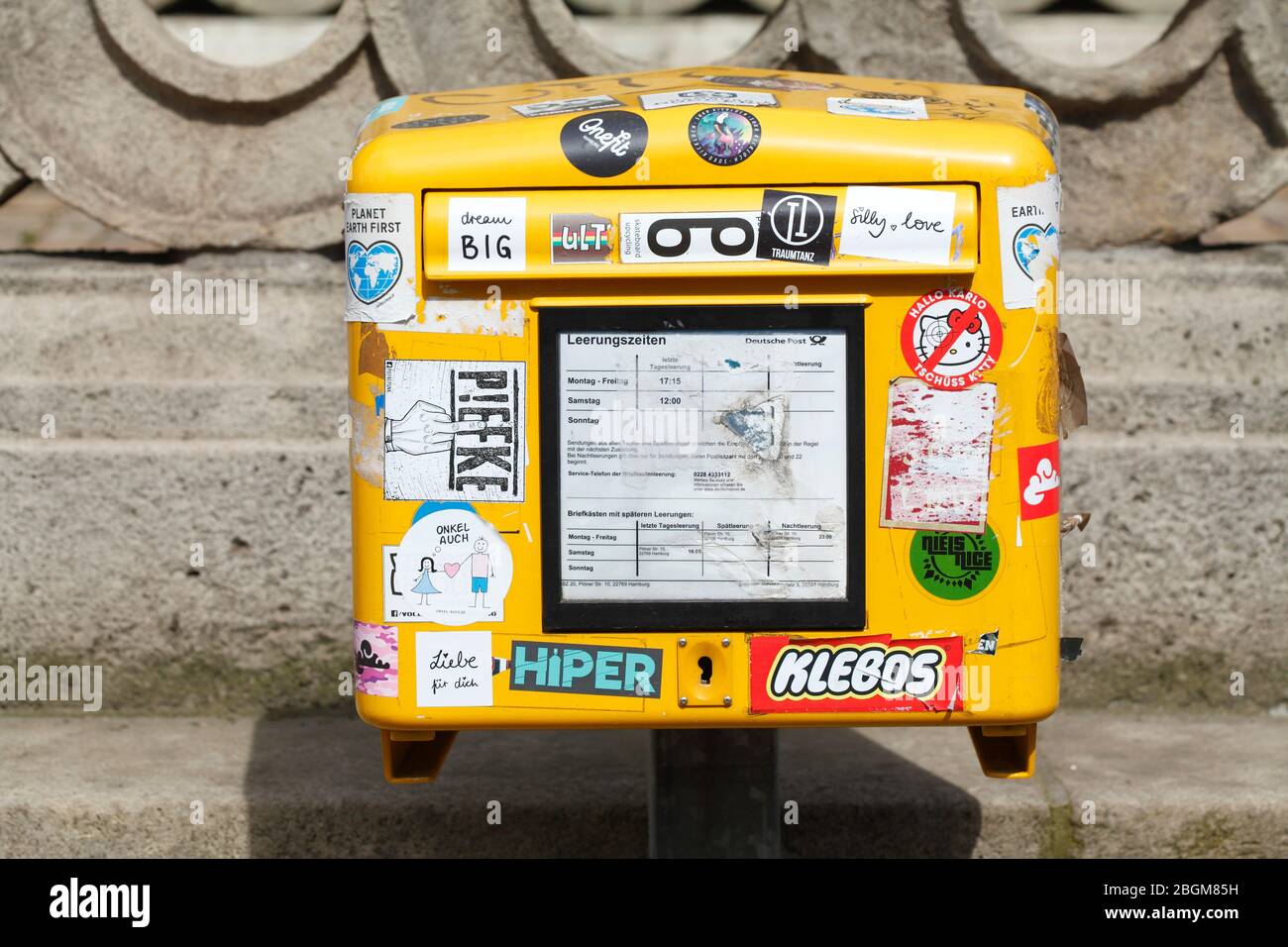 Yellow mailbox with nucleus, Germany Stock Photo - Alamy