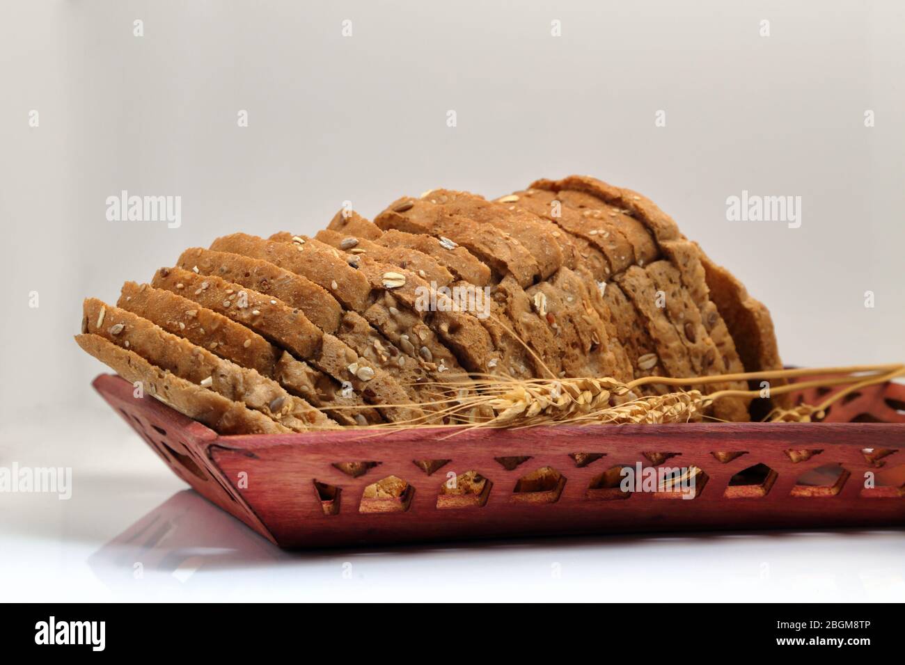 Fresh multi grain bread in wooden trey with barley Stock Photo - Alamy