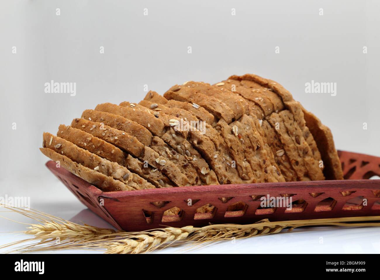 Fresh multi grain bread in wooden trey with barley Stock Photo - Alamy