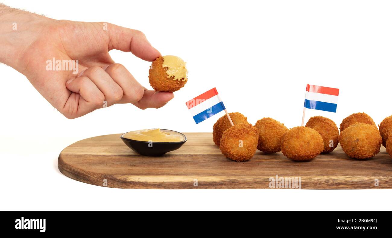 Dutch traditional snack bitterbal in a hand, isolated Stock Photo - Alamy