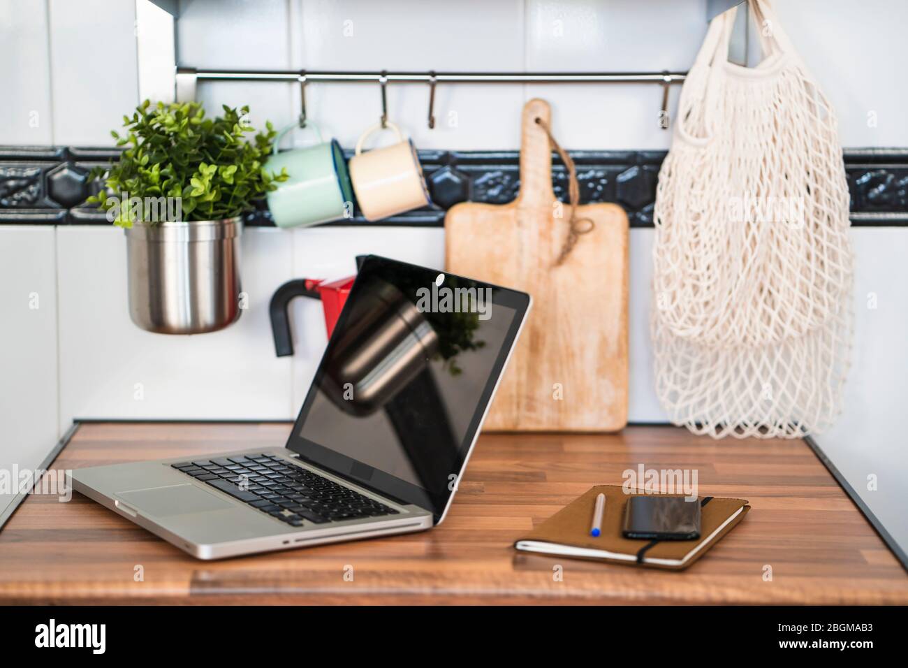 Little cute workspace in the kitchen with a laptop, smartphone and ...