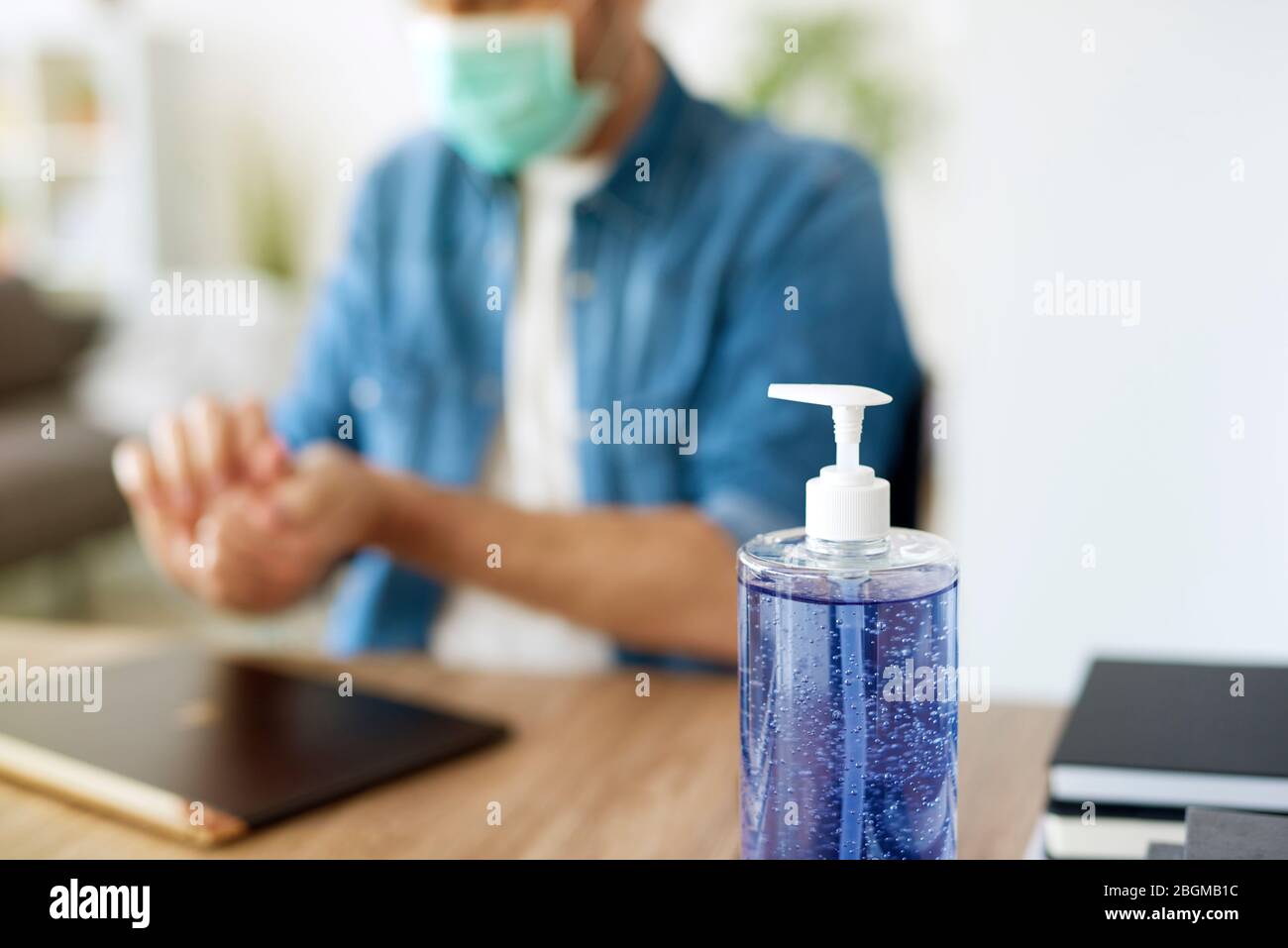 Detail of antibacterial soap and blurred working man Stock Photo - Alamy