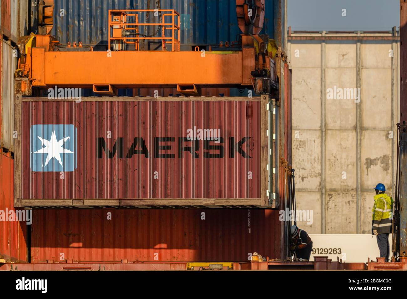 Unloading containers with the Maersk logo on board the ship Stock Photo ...