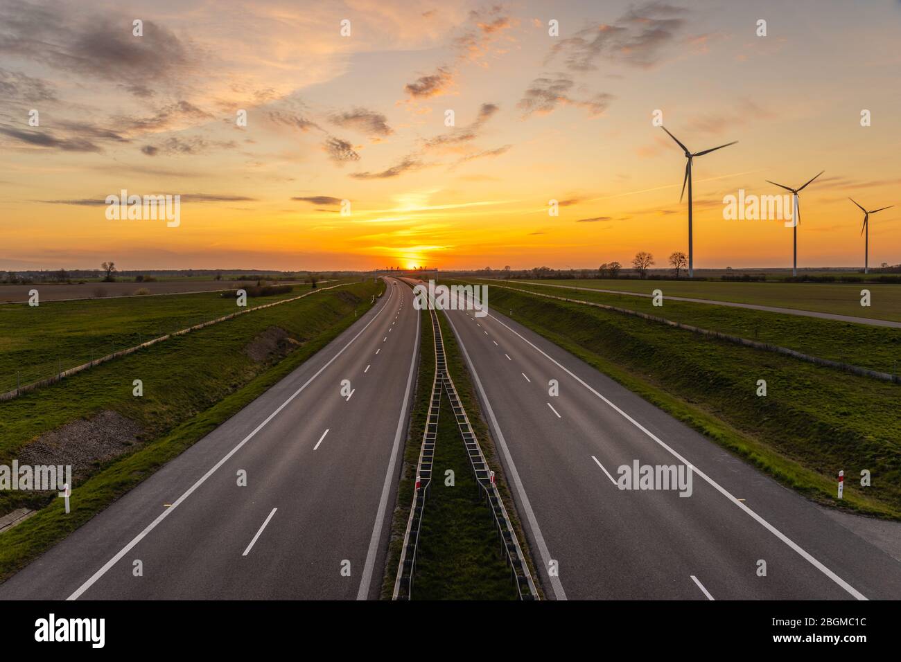 setting sun over an empty highway Stock Photo - Alamy