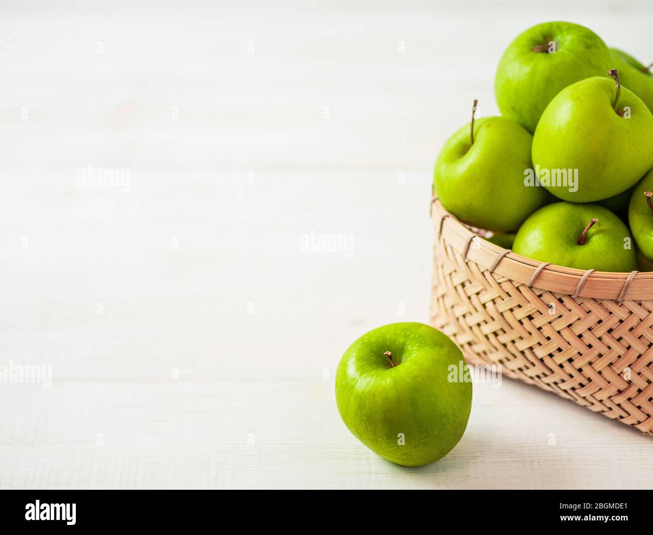 Apples harvest concept. Braided Bamboo Basket with green apples on ...