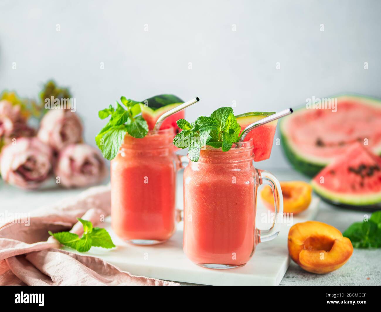 Freshly Blended Watermelon and Peach Smoothies in mason jar and metal ...