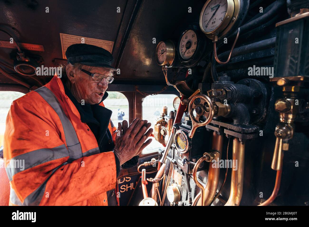 A man in the cab holding his hands together whilst talking Working ...