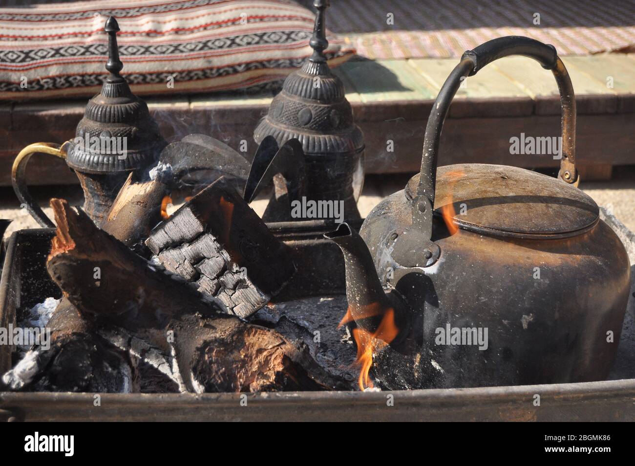 A seared kettle on glowing woods. Making coffee for tourists on the ...