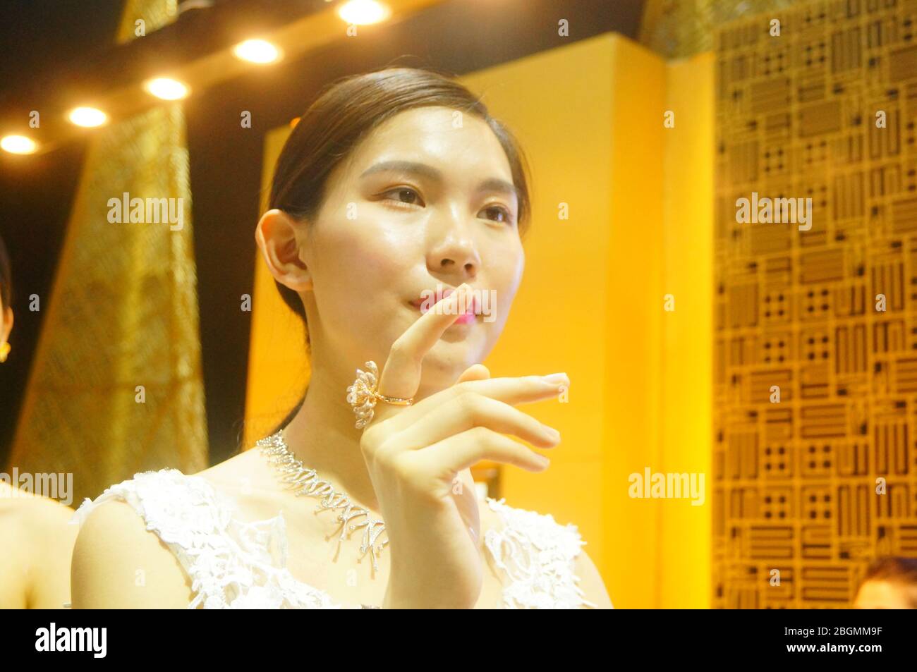 Female models display new gold jewelry Stock Photo - Alamy