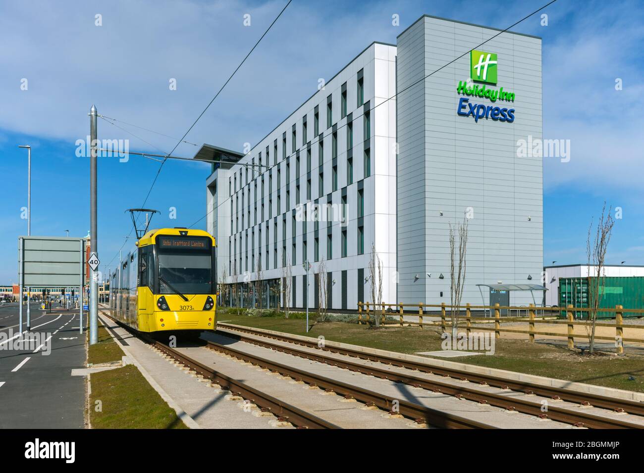 Metrolink tram passing the Holiday Inn Express on the opening day of ...