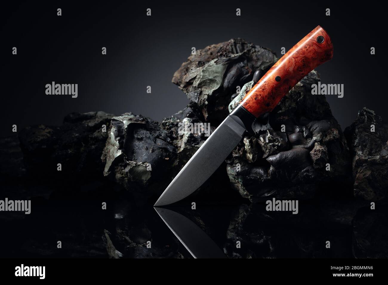 Hunter combat hand made knife and broken stones. The blade has a ...