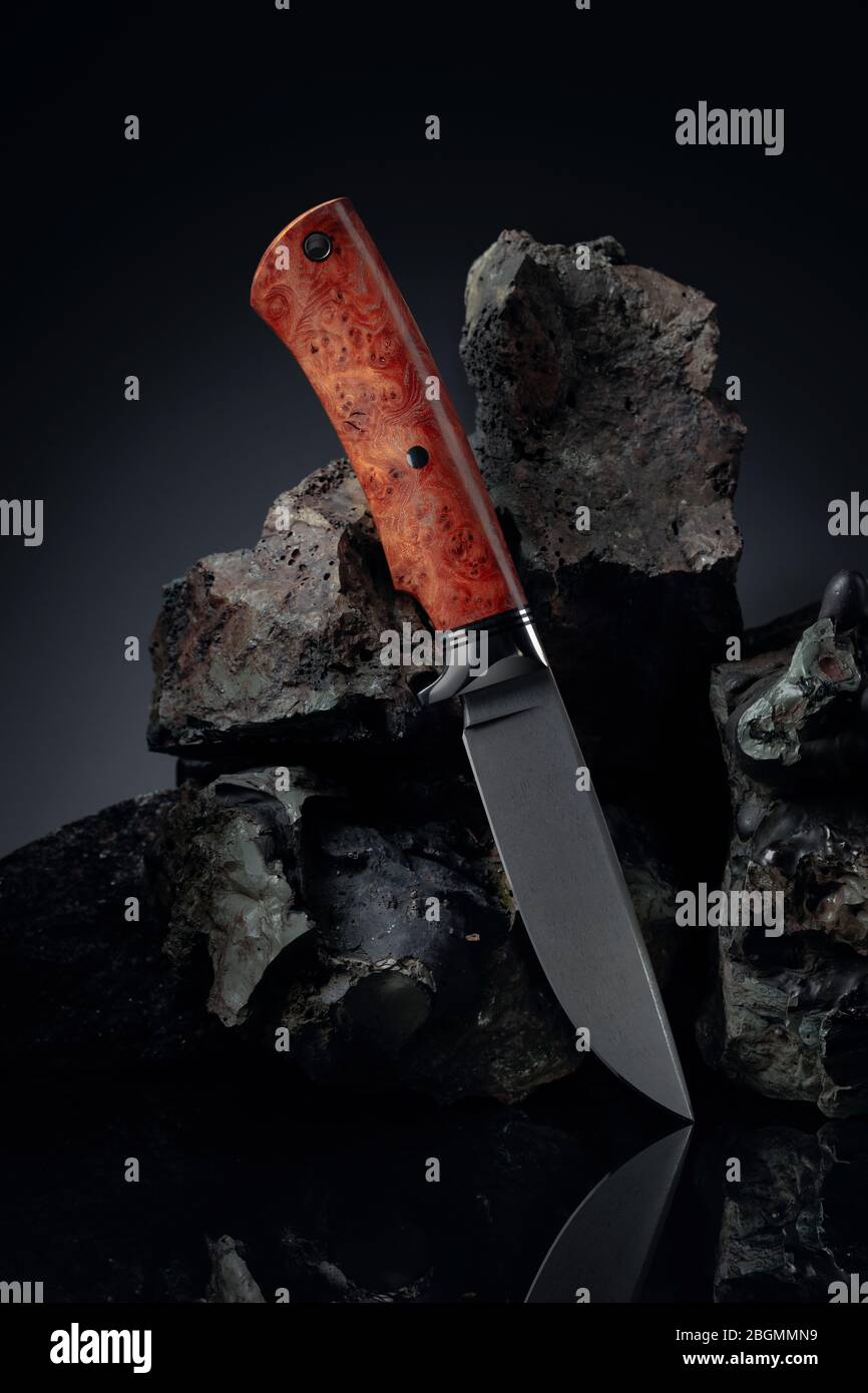 Hunter combat hand made knife and broken stones. The blade has a ...