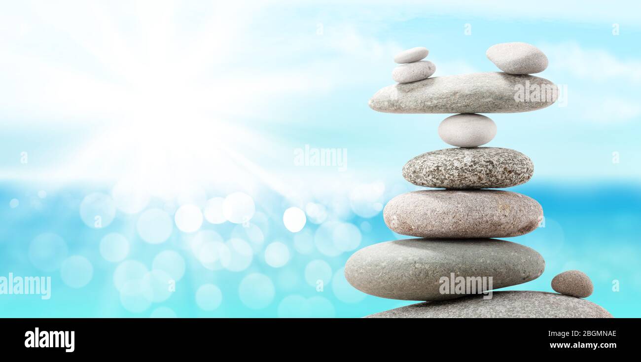 Pyramid of sea pebbles on a sunny beach. Life balance and harmony ...
