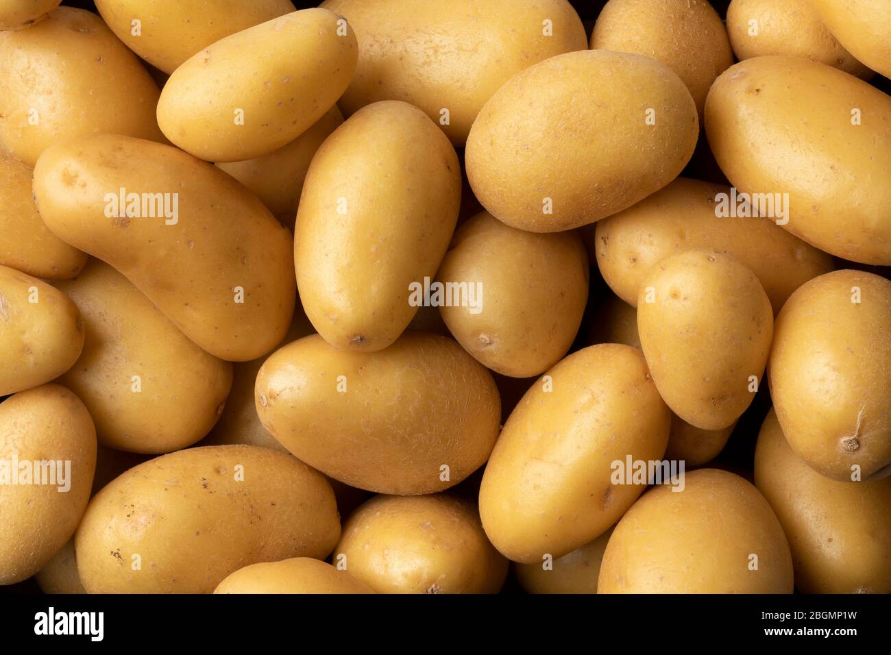 Fresh small new potatoes close up full frame Stock Photo - Alamy