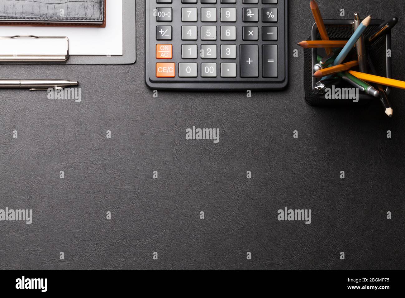 Office desk table with supplies. Dark workspace tabletop with copy ...