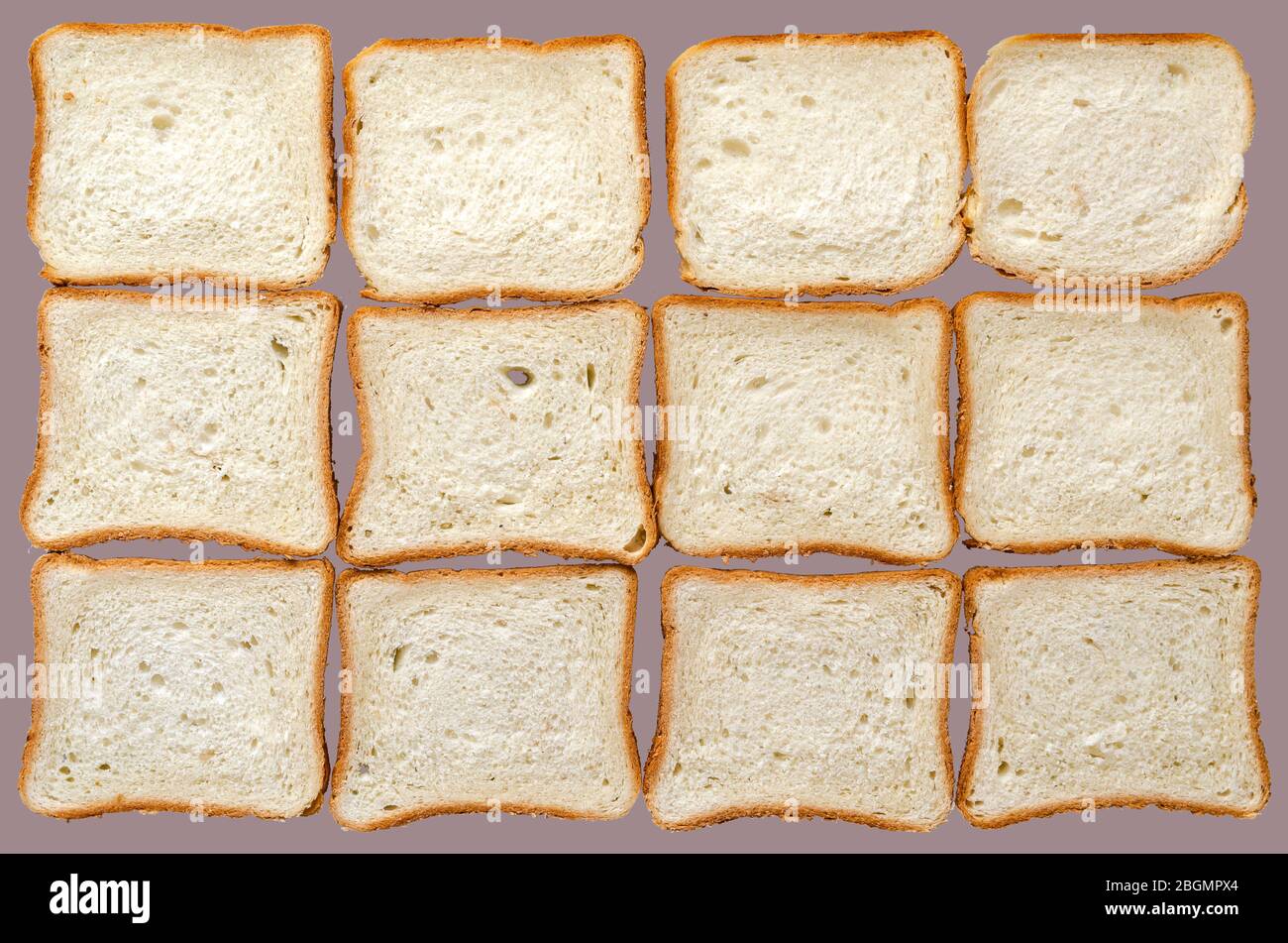 Toast bread background. Twelve slices of sliced bread on a gray ...