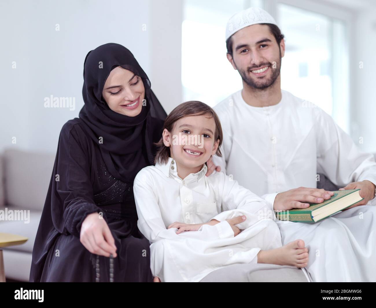 Traditional muslim family parents with children reading Quran and ...