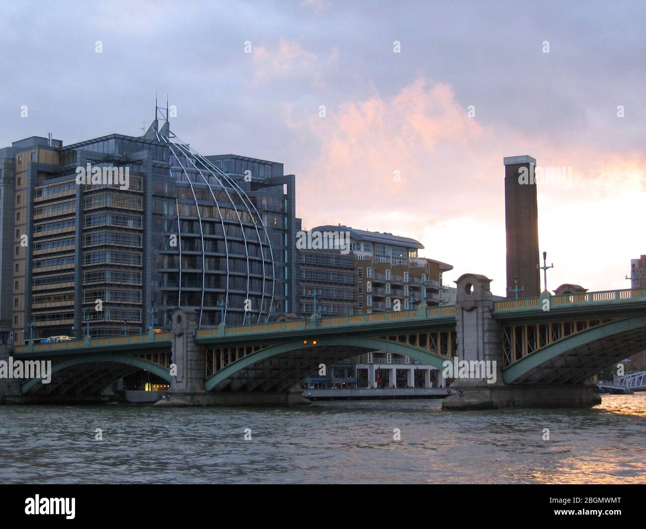 Southwark Bridge with city buildings and chimney of the Tate Modern ...