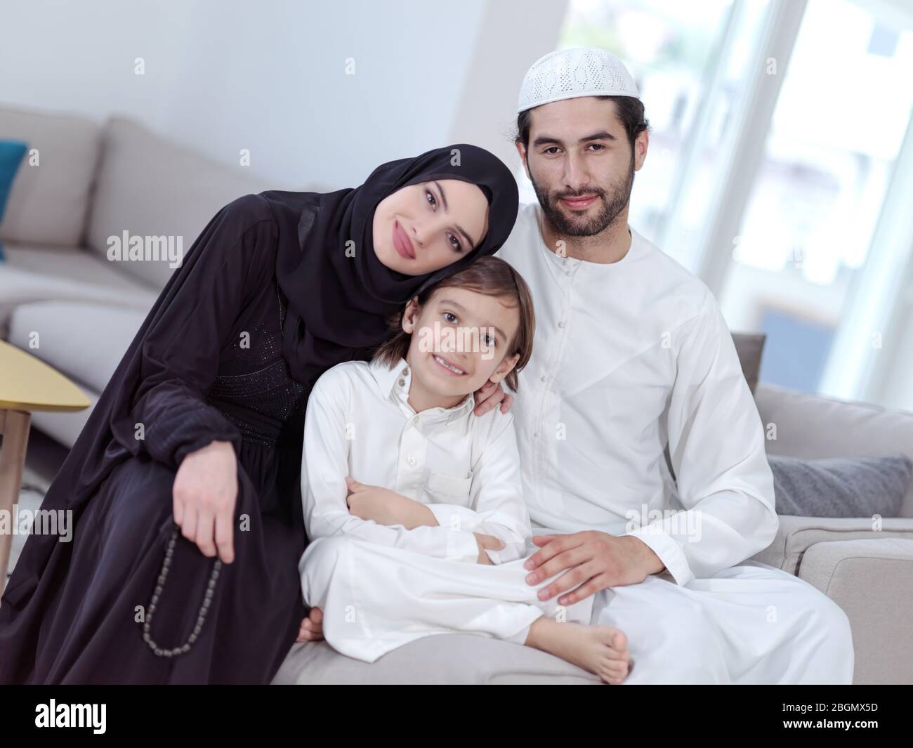 Traditional muslim family parents with children reading Quran and ...