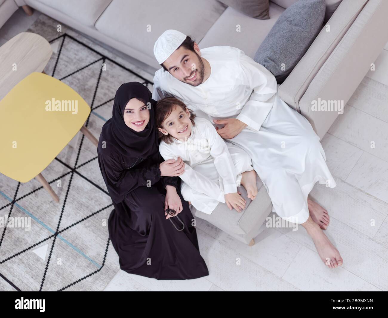 Traditional muslim family parents with children reading Quran and ...