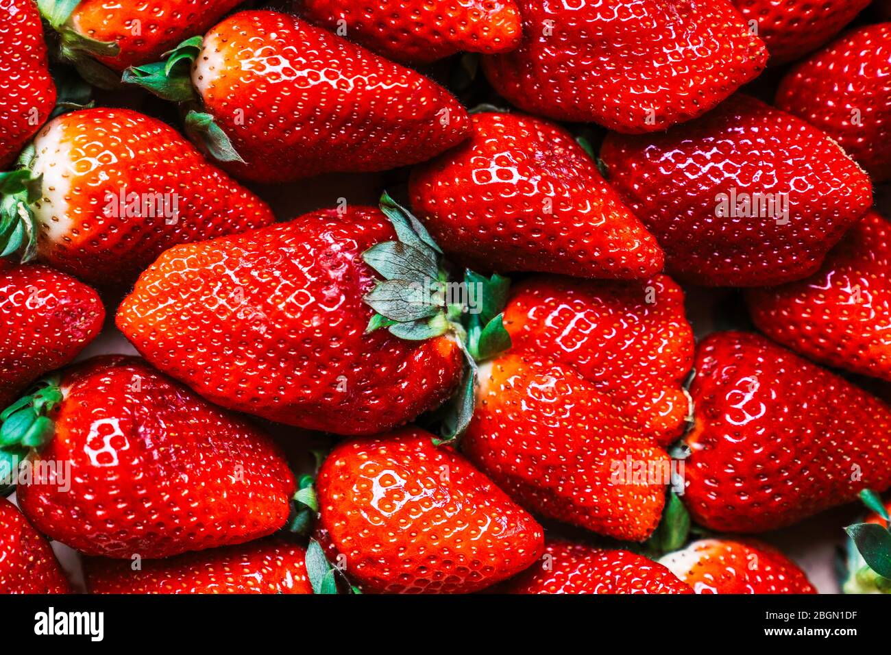 Group of bright red shiny strawberries hi-res stock photography and ...