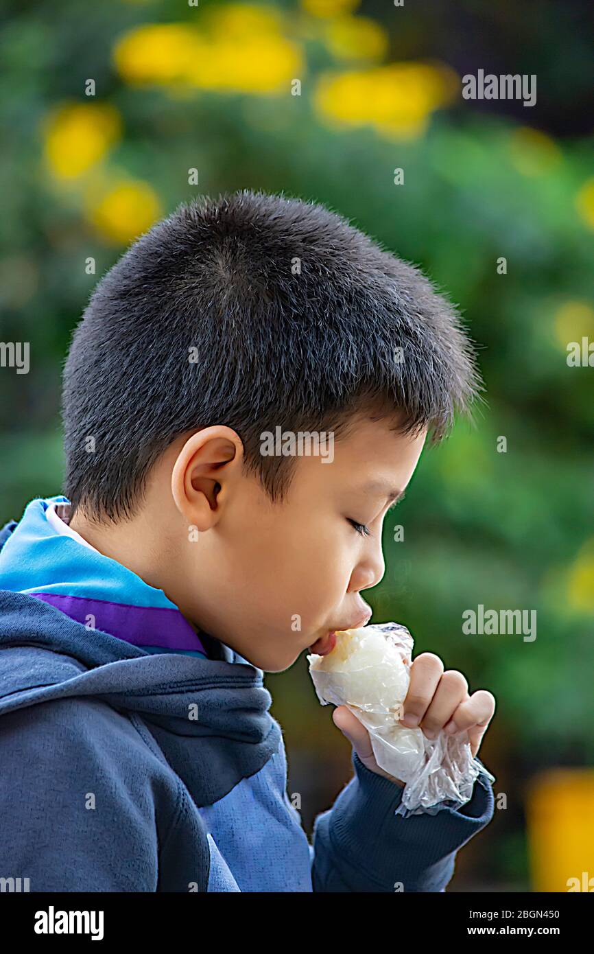 Child eating rice hi-res stock photography and images - Alamy