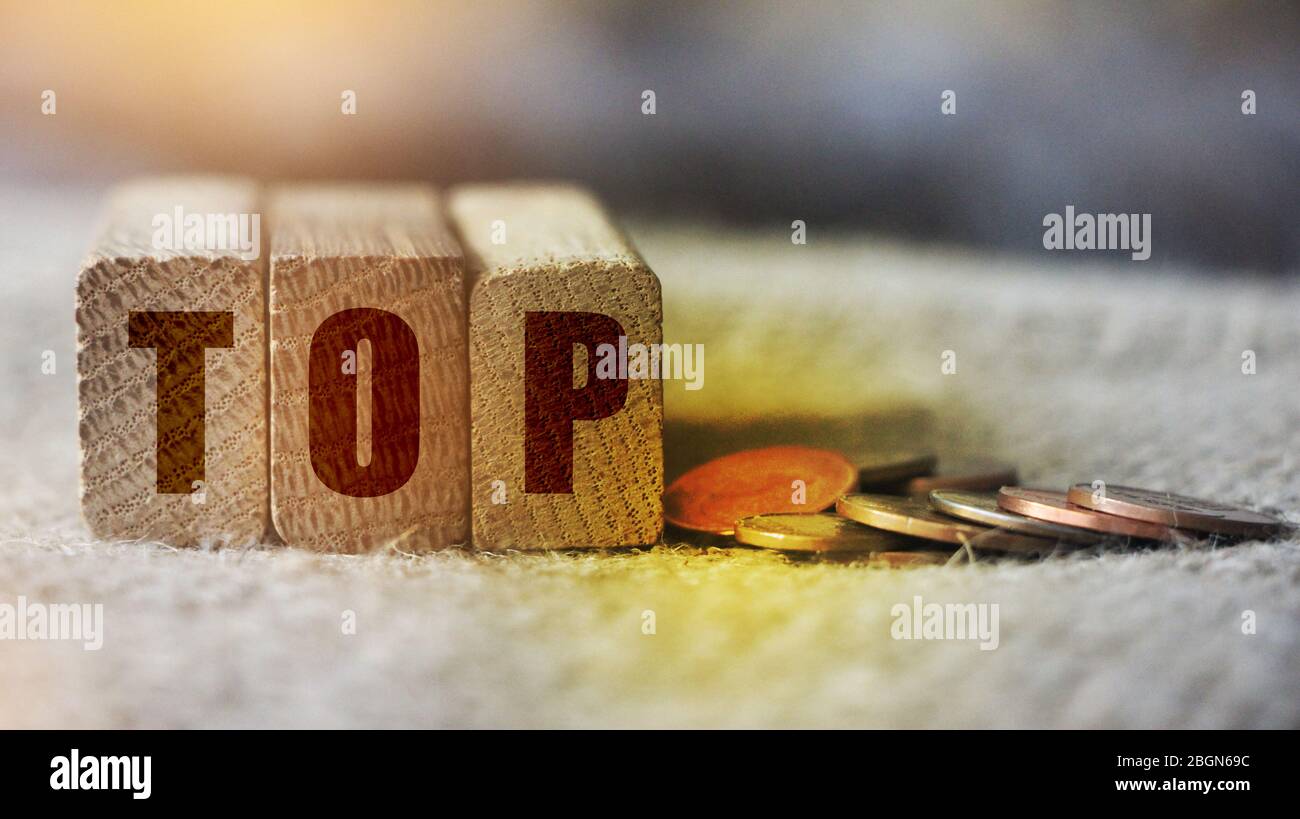 Top word written on wooden blocks and coins besides on burlap ...
